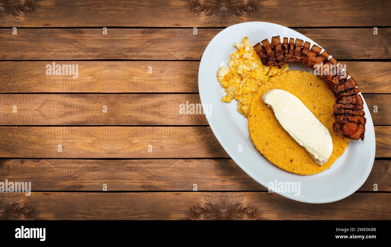 Breakfast served at the table - Corn arepa, cheese, pork rinds and ...