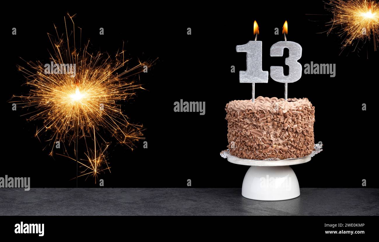 Birthday cake with burning candle number 13 hi-res stock photography ...