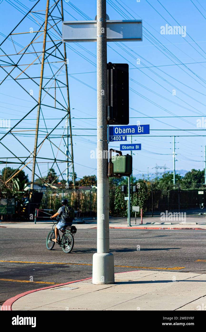 Man riding his bike past a sign for Obama Boulevard in the Baldwin ...