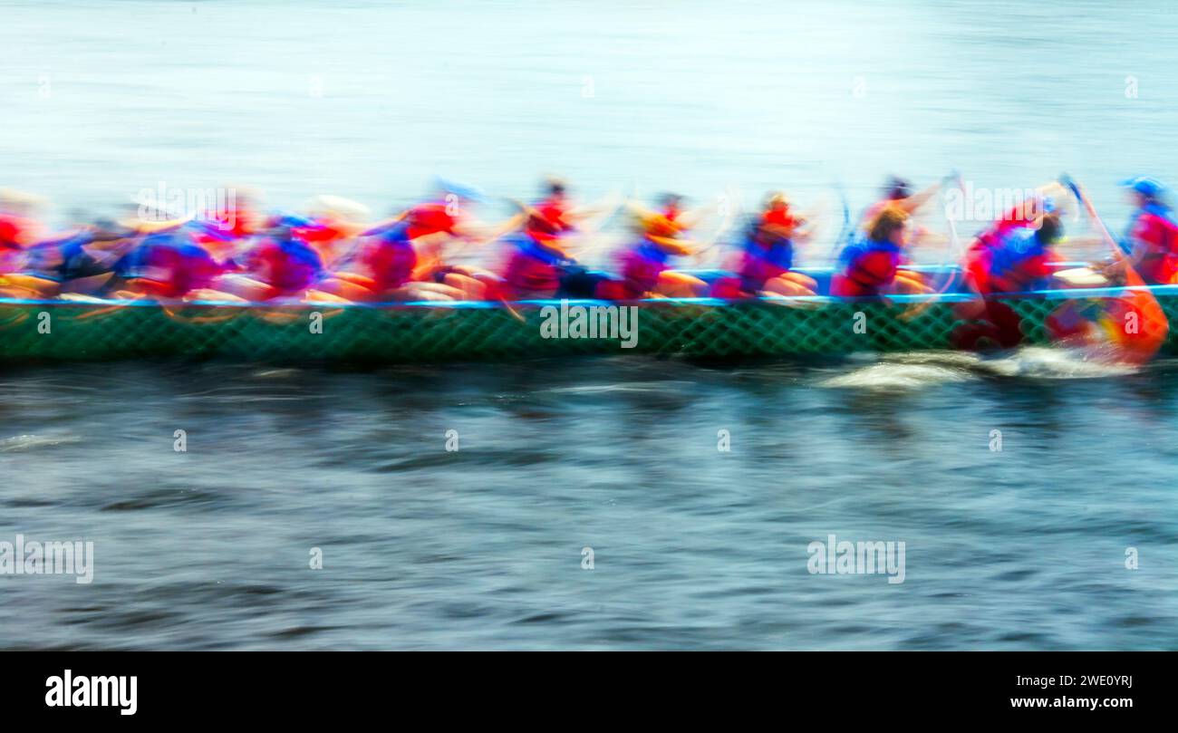 Dragon boat competing in a race, dynamic blurred motion as the ...