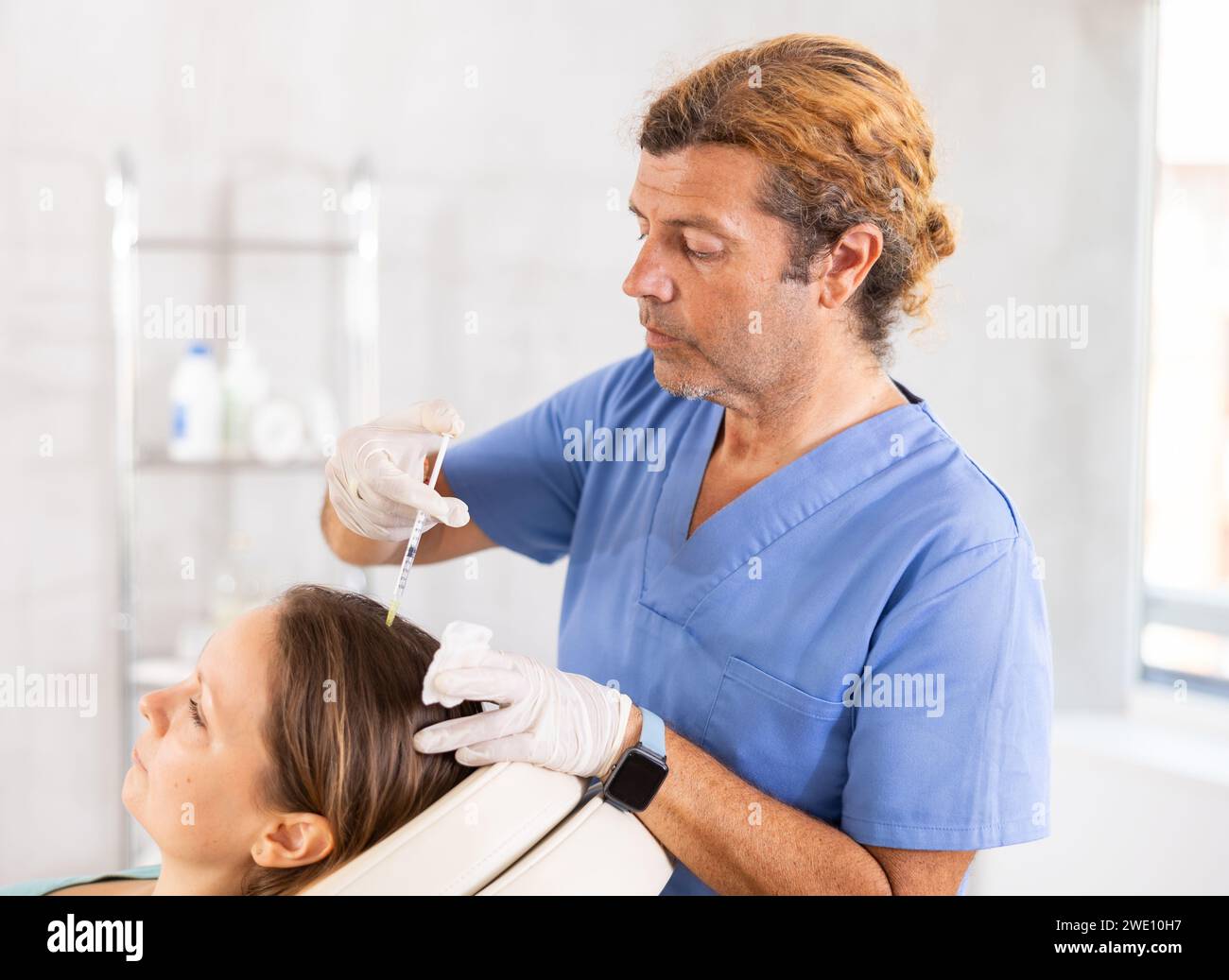 Woman applying scalp injection treatments by male doctor Stock Photo ...
