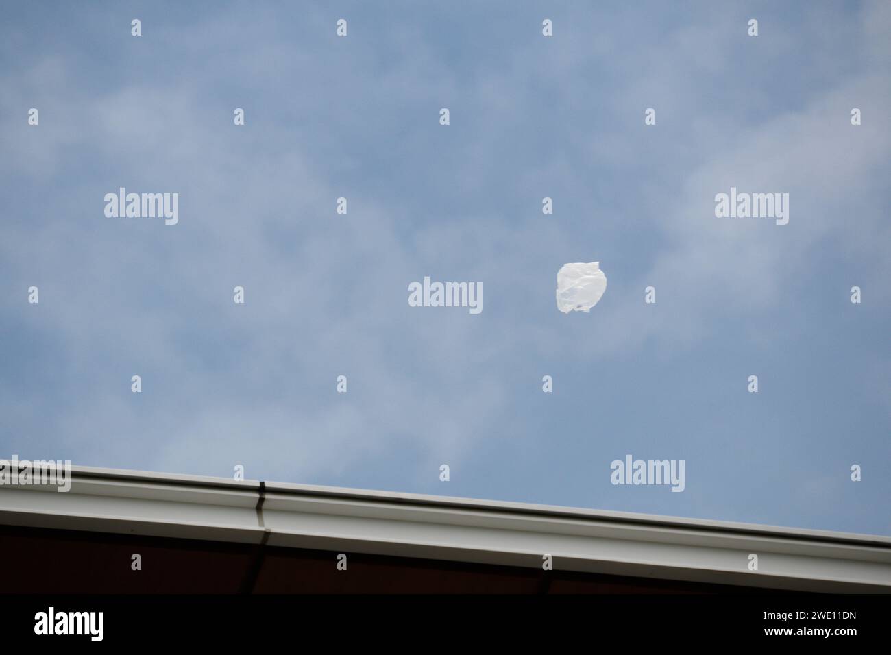 Plastic carrier bag flying high in the sky Stock Photo - Alamy