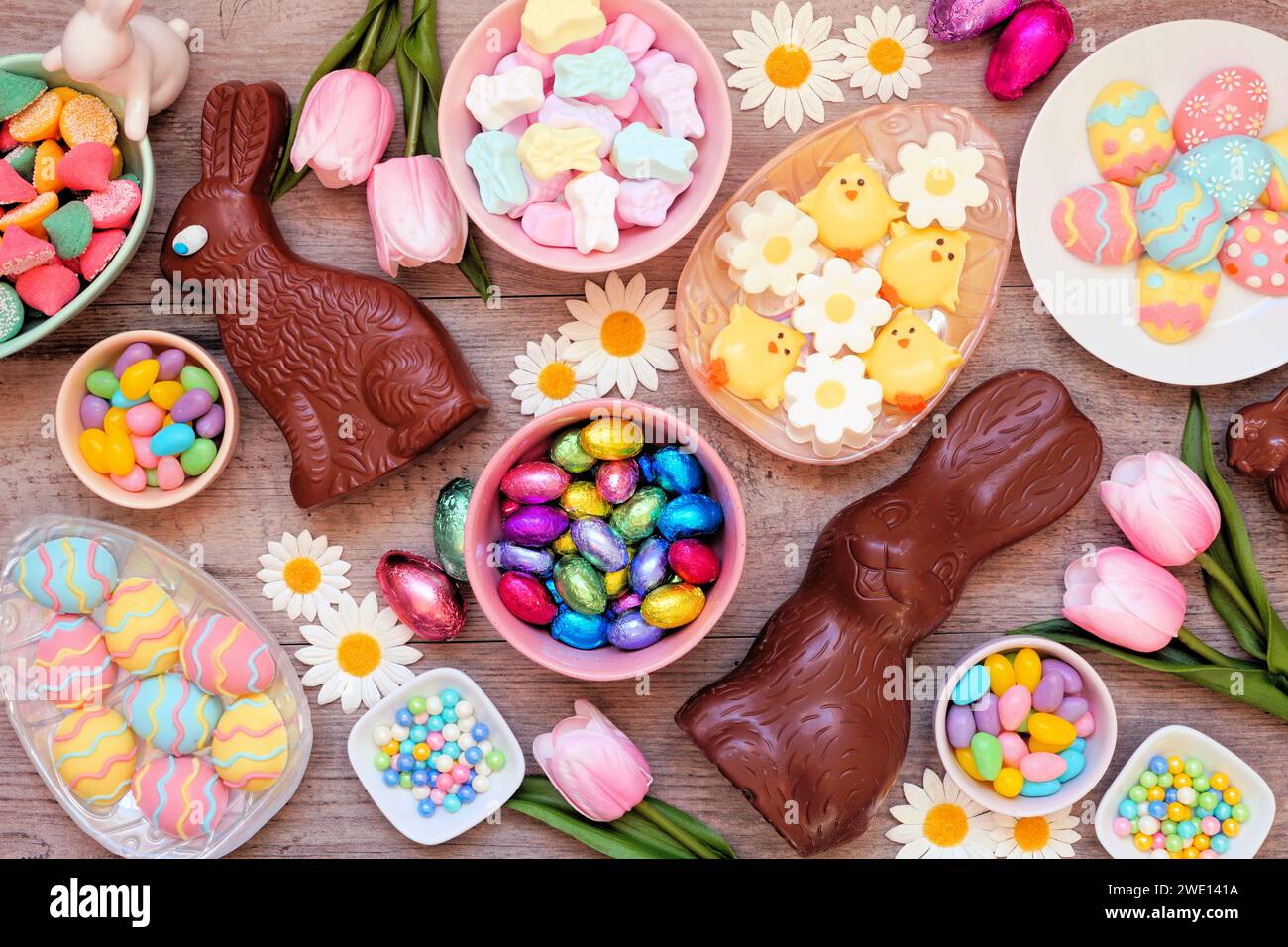 Easter candies. Top view table scene over a wood background. Chocolate ...