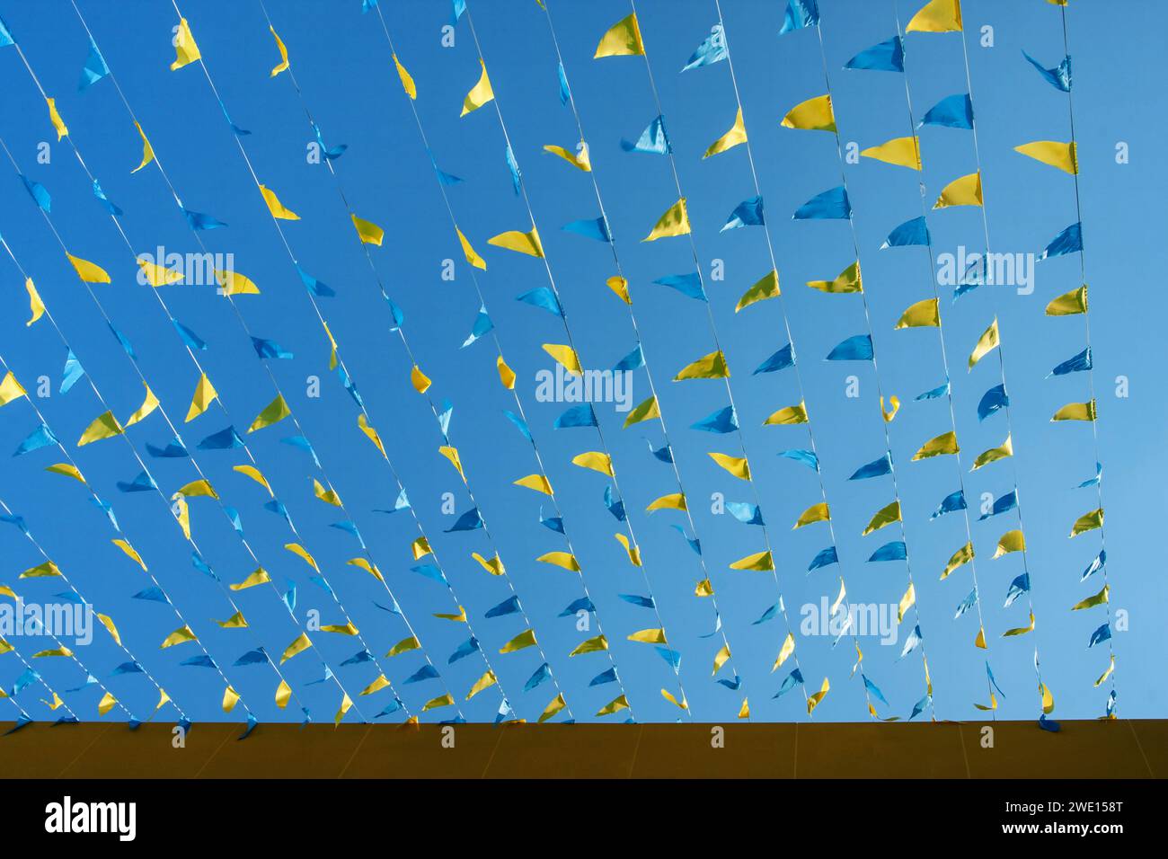 Colorful flags on the roof of a building against the blue sky Stock ...