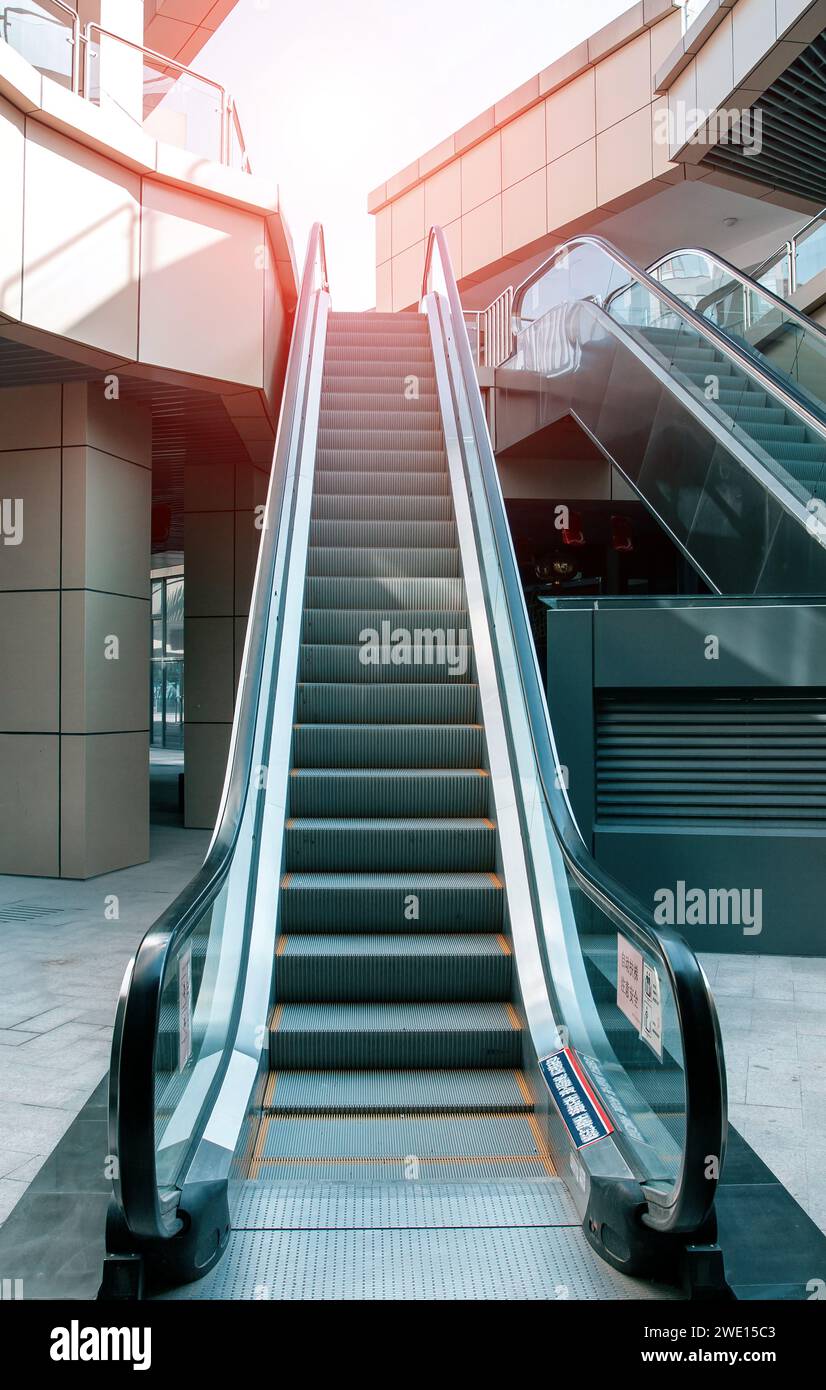 Escalators in a modern shopping center Stock Photo - Alamy