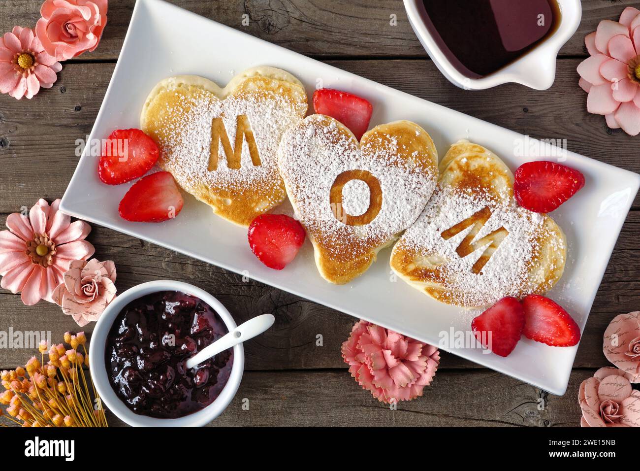 Heart shaped pancakes with MOM letters. Mothers Day breakfast concept ...