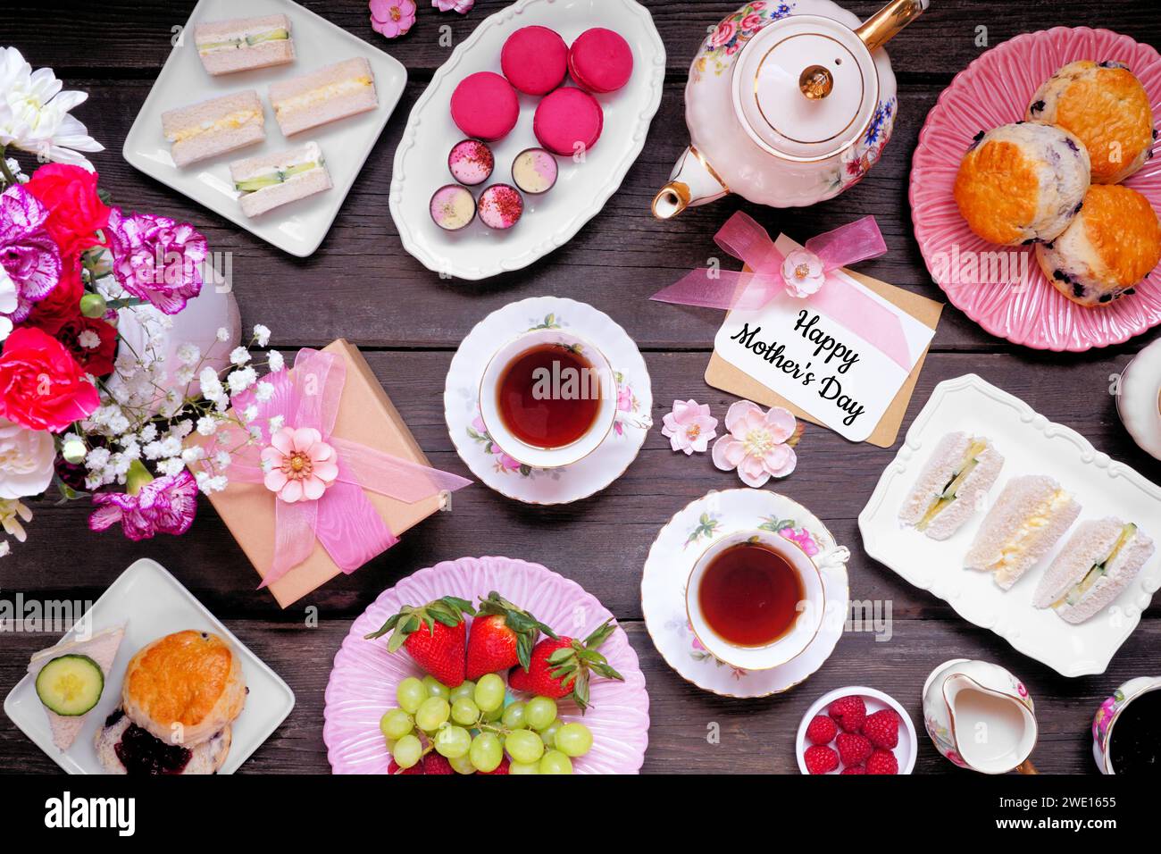 Mother's Day tea table scene over a dark wood background. Greeting card ...