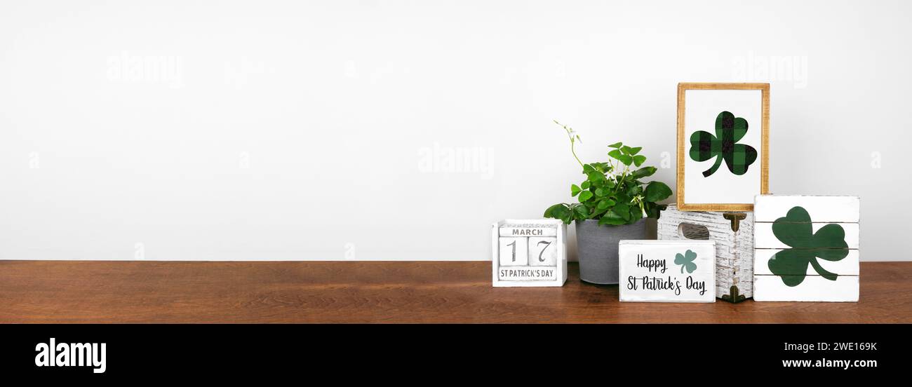 St Patricks Day decor on a wood shelf. Shamrock plant, shabby chic wood ...