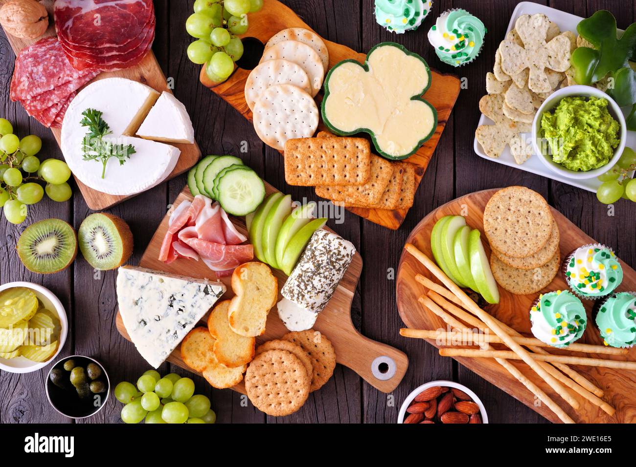 St Patricks Day theme charcuterie table scene against a wood background ...
