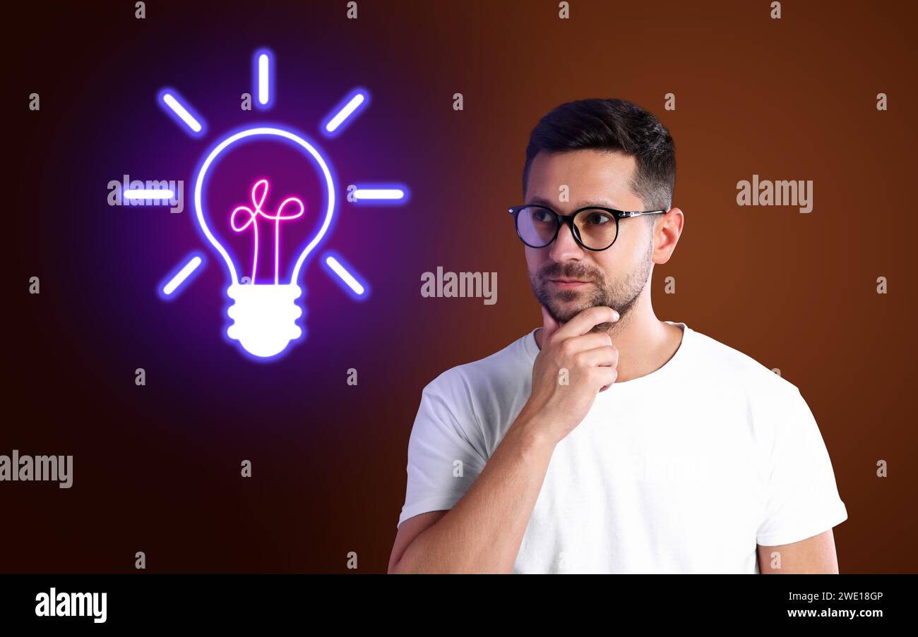 Idea generation. Thoughtful man and illustration of glowing light bulb ...