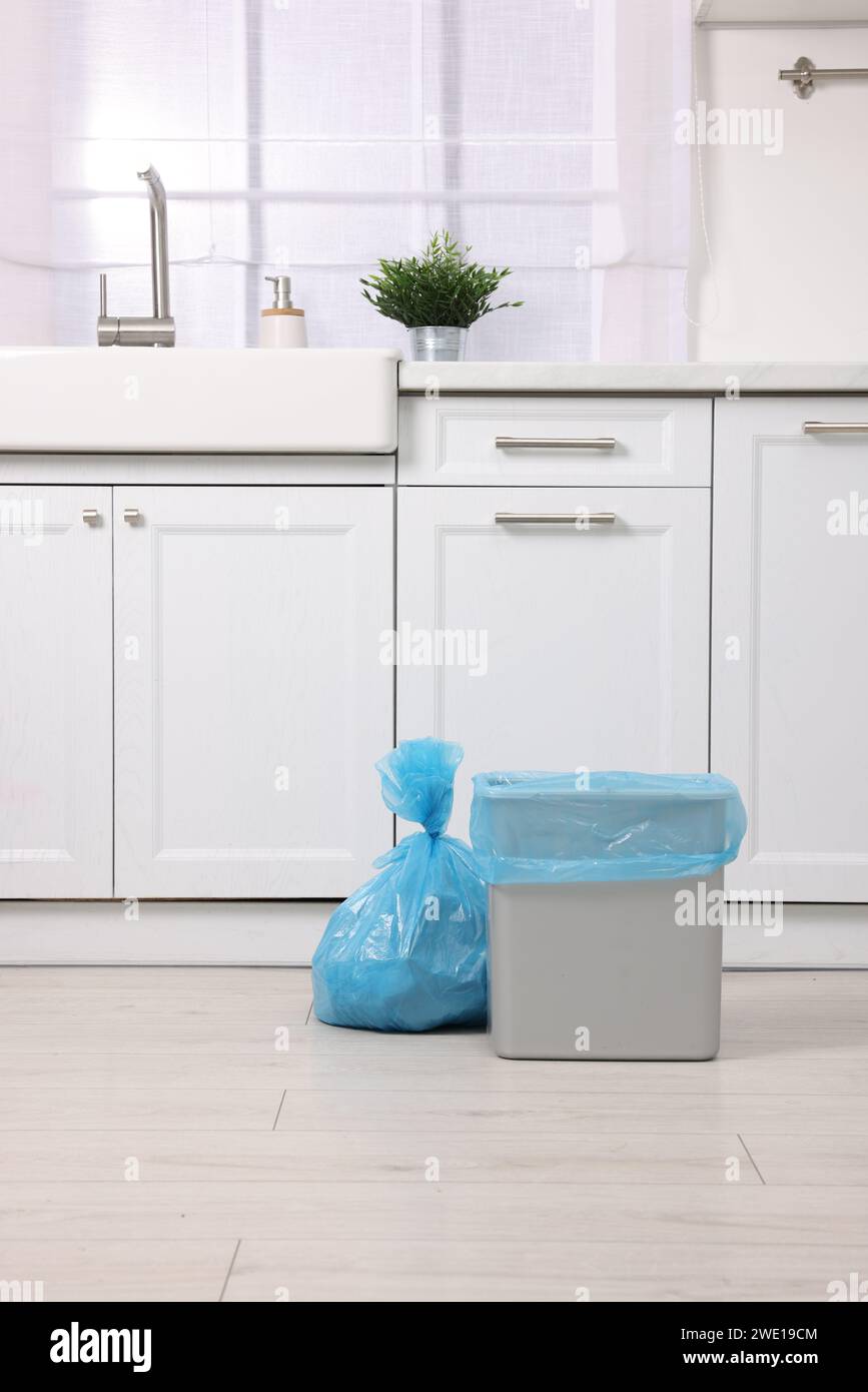 Plastic garbage bag and trash can in kitchen Stock Photo - Alamy