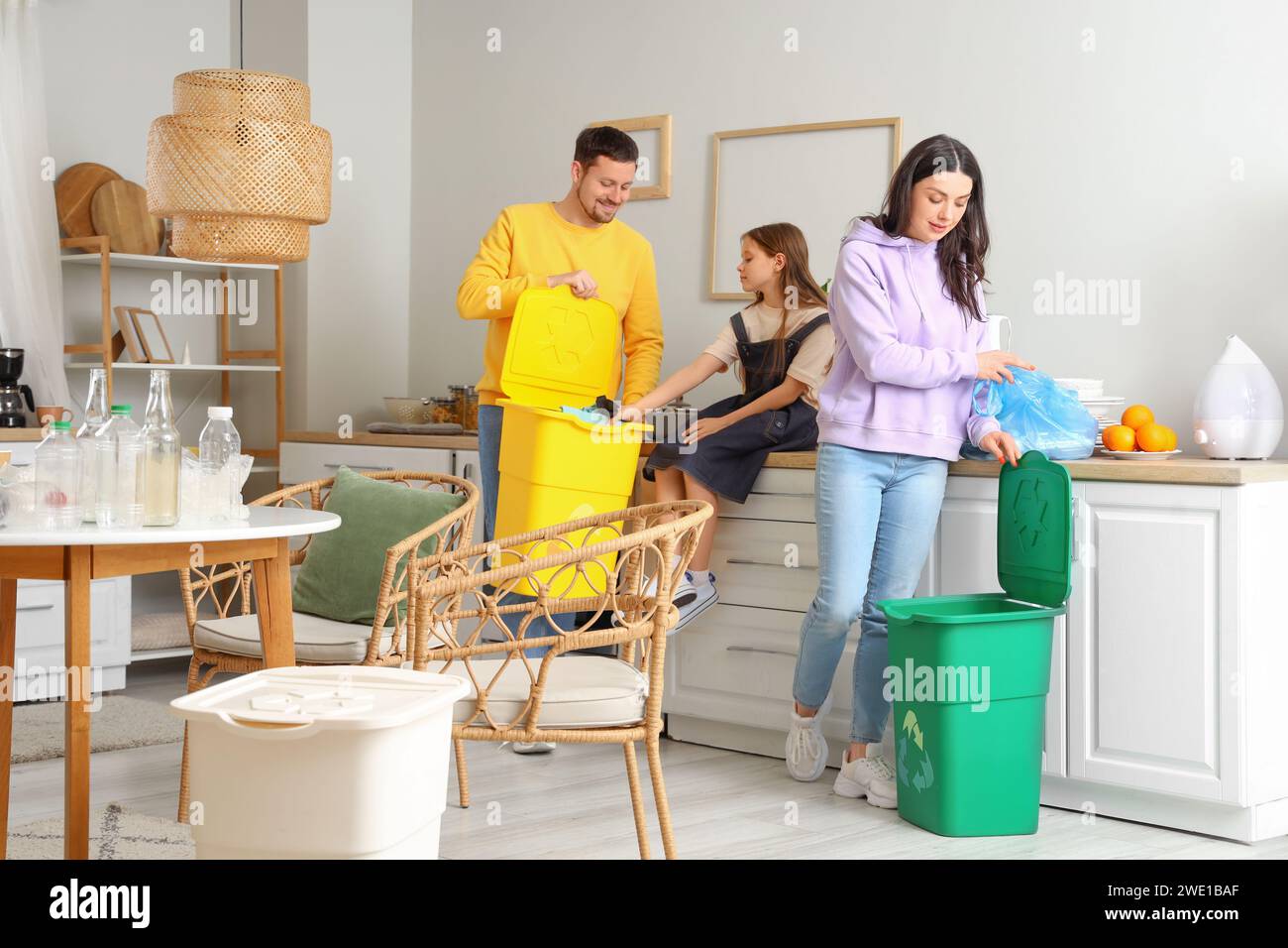 Mother daughter sorting recycling waste kitchen hi-res stock ...