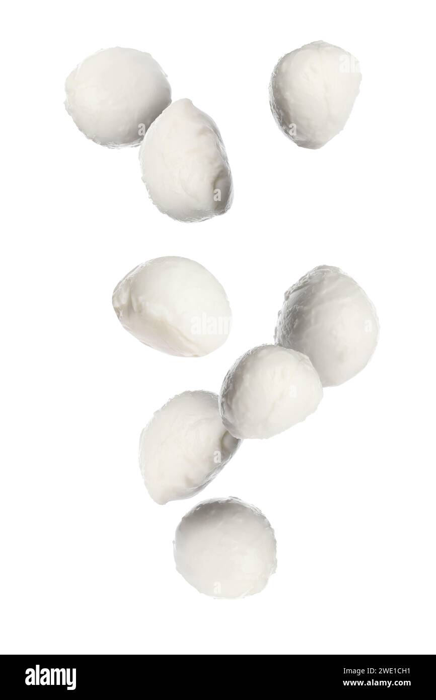 Fresh mozzarella balls falling on white background Stock Photo - Alamy