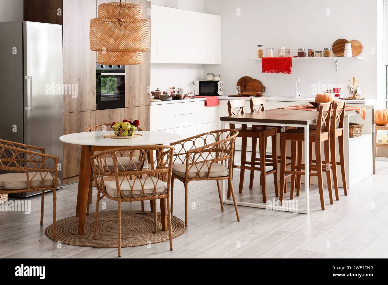 Interior of modern kitchen with tables, counters and built-in oven ...