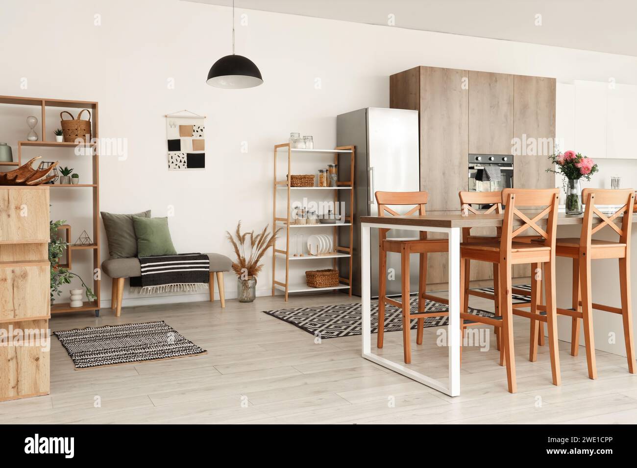 Interior of kitchen with table and shelf units Stock Photo - Alamy