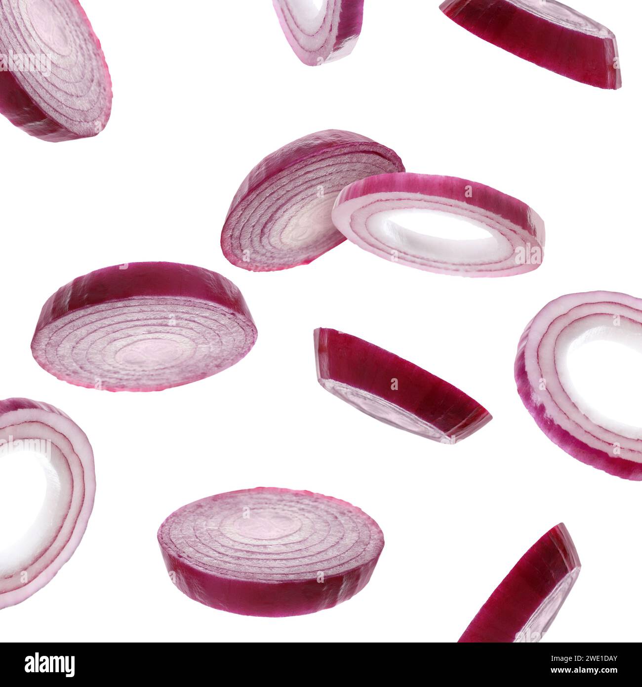 Fresh onion slices falling on white background Stock Photo - Alamy
