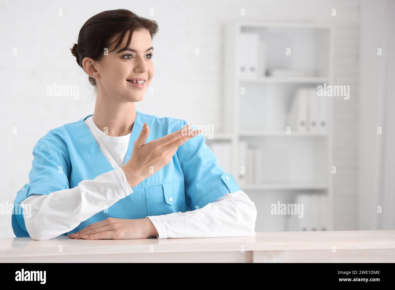 Female medical intern at reception in clinic Stock Photo - Alamy