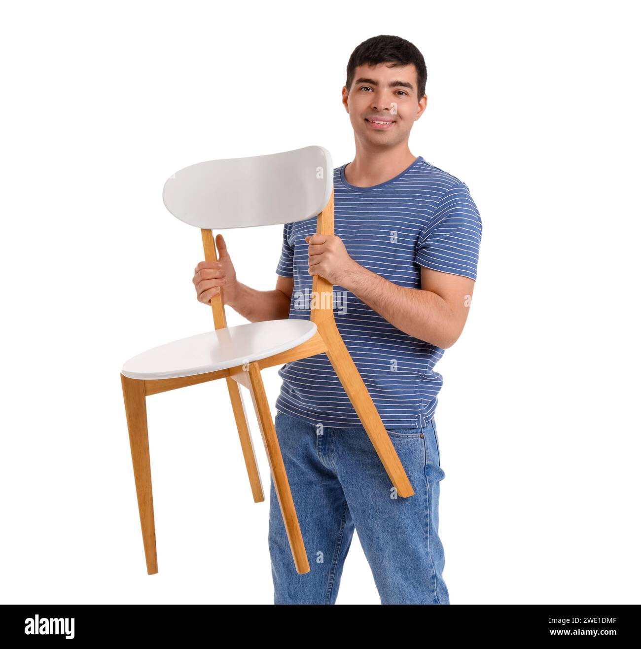 Young man carrying chair on white background Stock Photo - Alamy