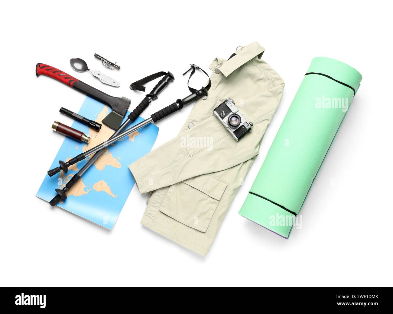 Set of hiking essentials with trekking poles, hatchet and map on white ...