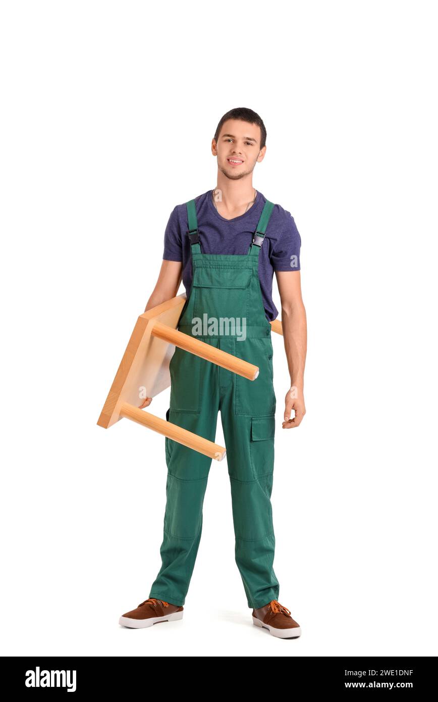 Young loader carrying wooden bench on white background Stock Photo - Alamy