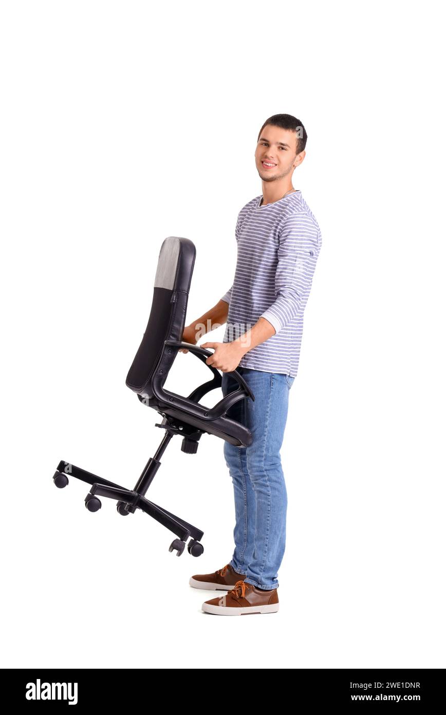 Young man carrying office chair on white background Stock Photo - Alamy