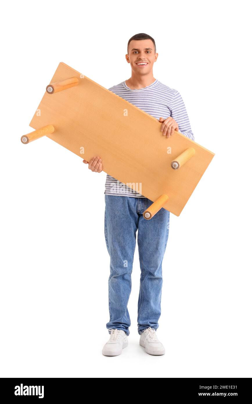 Young man carrying table on white background Stock Photo - Alamy