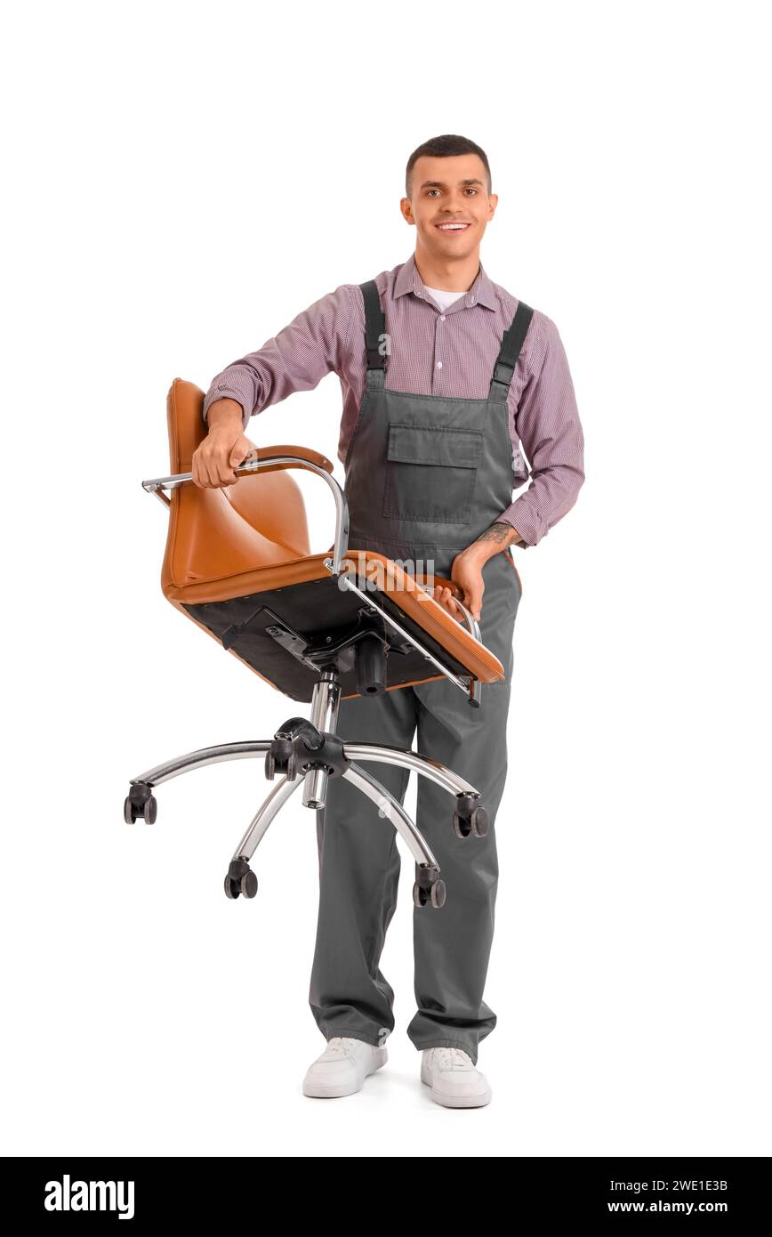 Young loader carrying office chair on white background Stock Photo - Alamy