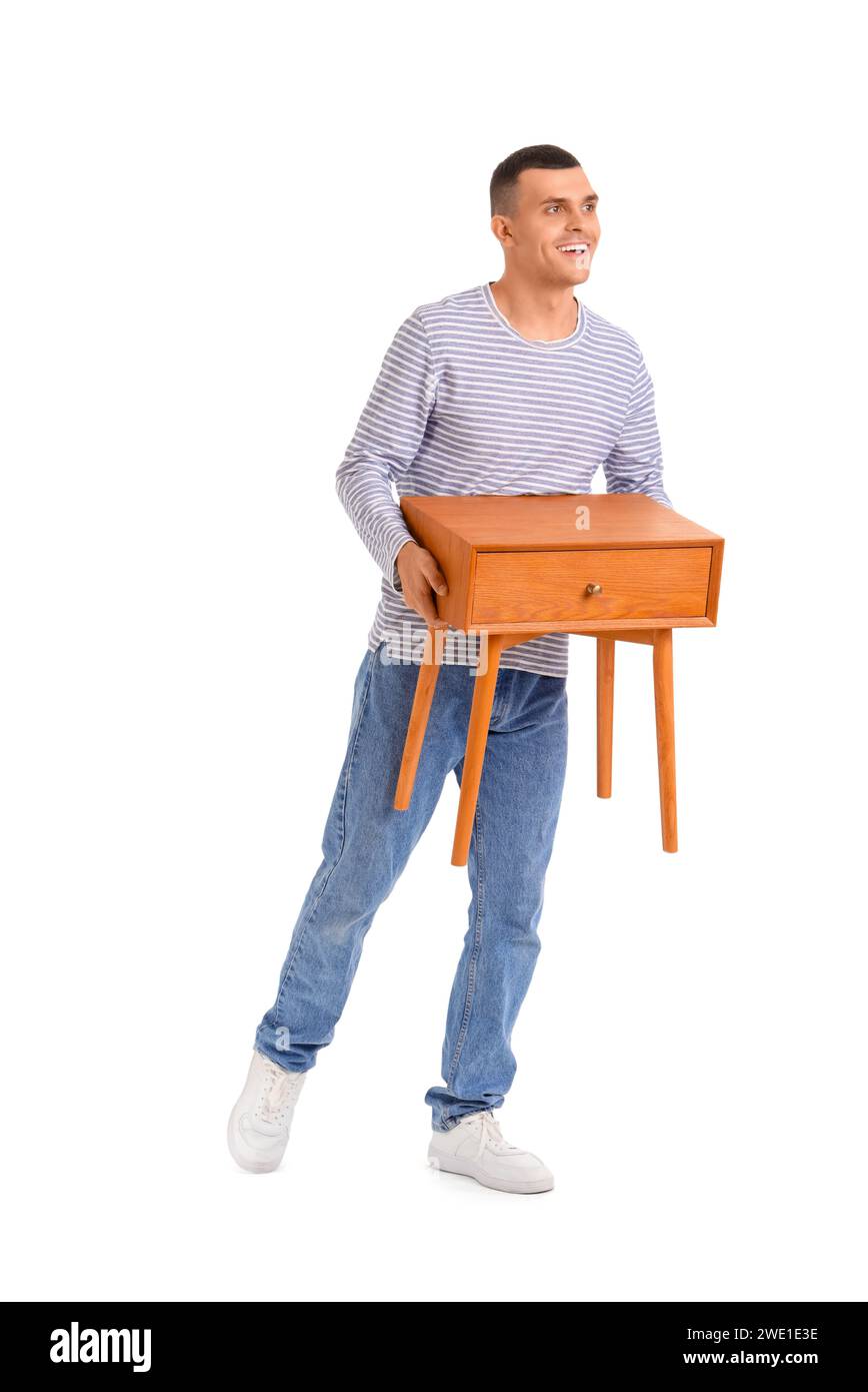 Young man carrying table on white background Stock Photo - Alamy