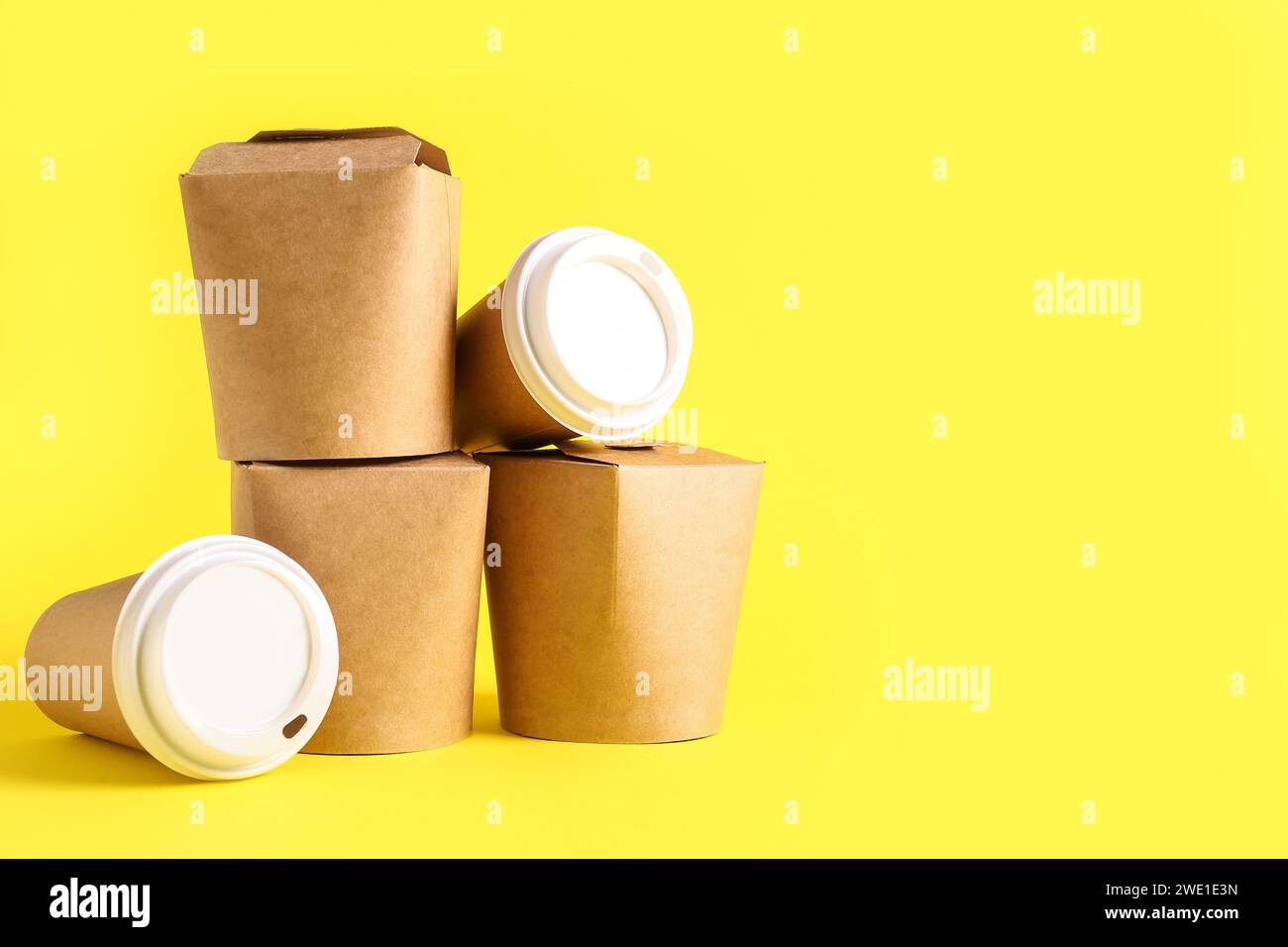 Takeaway paper cups and boxes on yellow background Stock Photo - Alamy