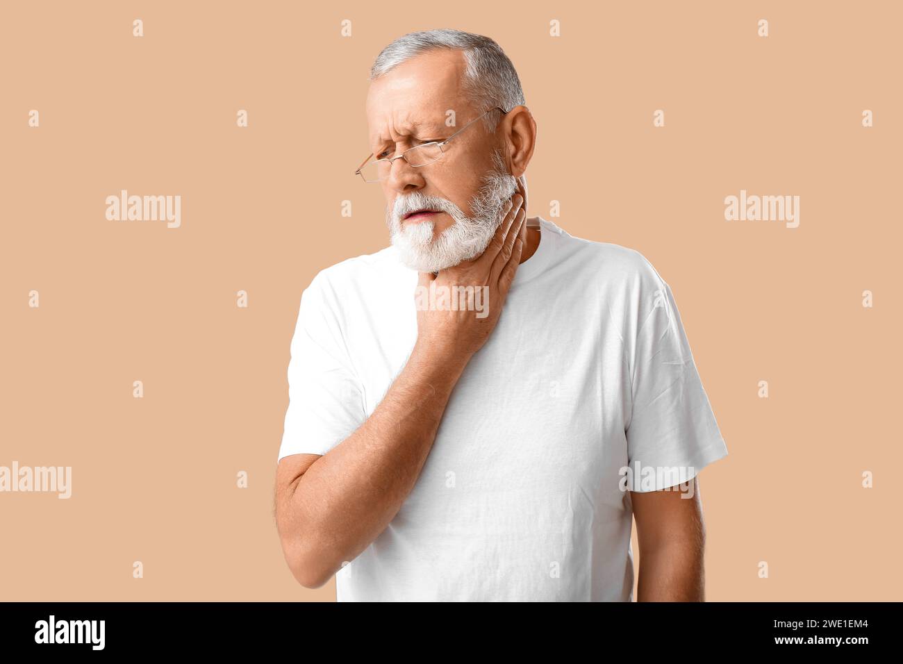 Ill old man with sore throat on beige background Stock Photo - Alamy