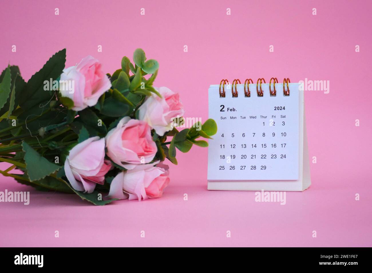 Desk calendar for February 2024 on a pink background with roses Stock ...