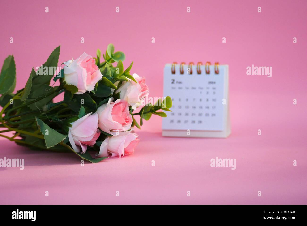 Desk calendar for February 2024 on a pink background with roses Stock ...