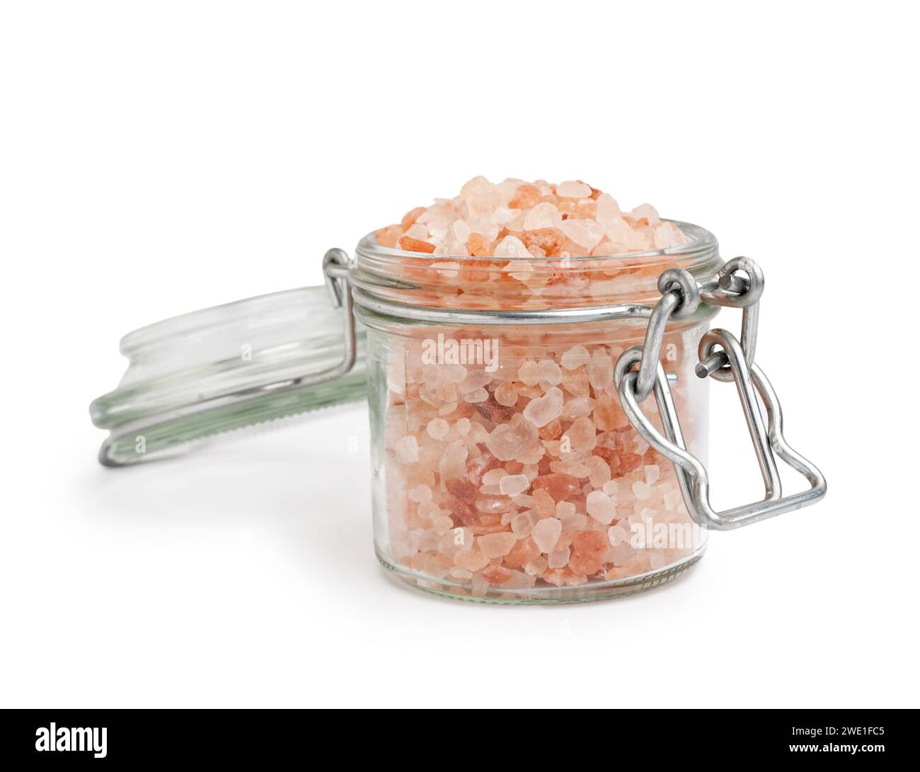 Jar with Himalayan pink salt on white background Stock Photo - Alamy