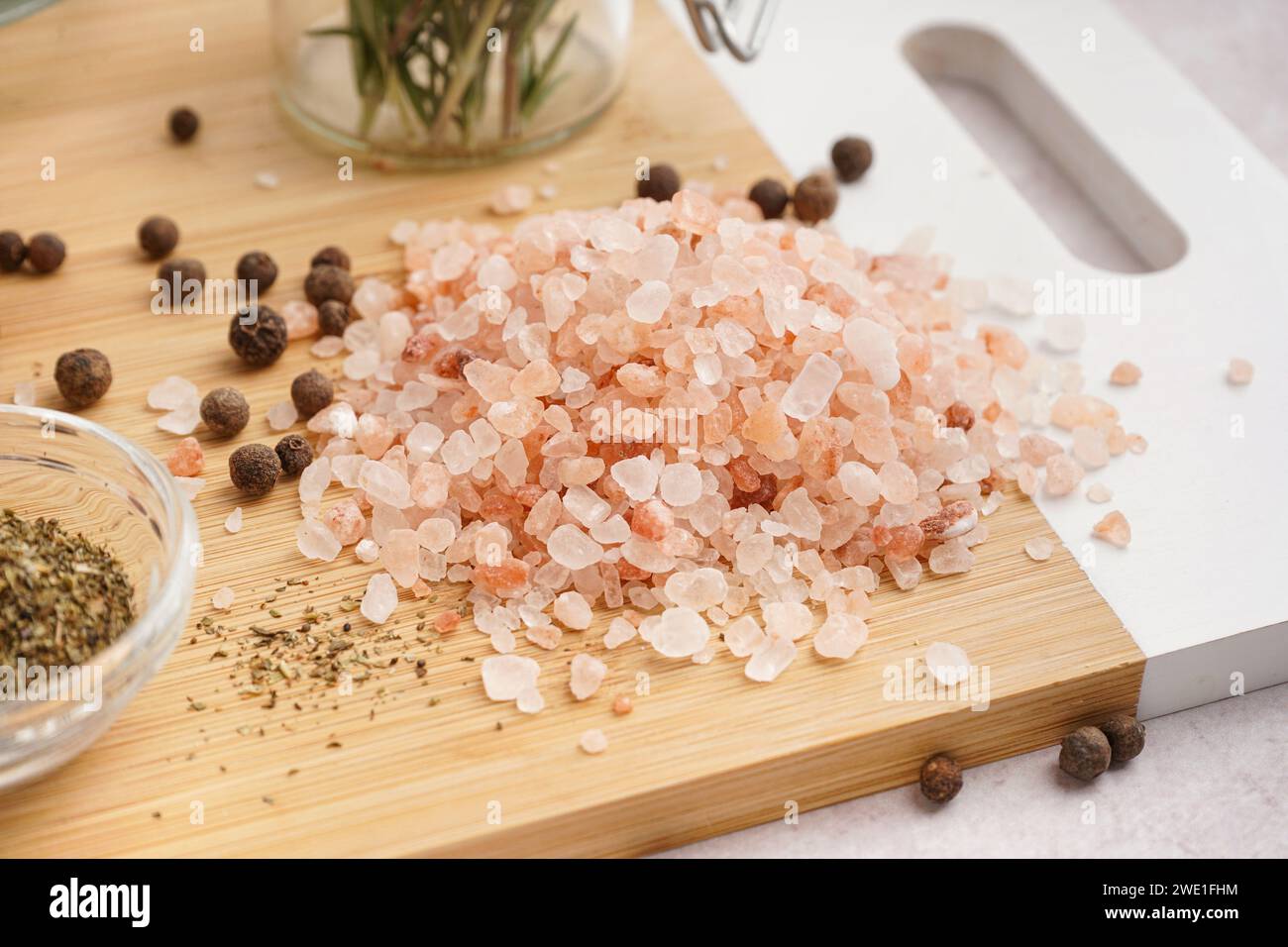Board with Himalayan pink salt and peppercorn on white background Stock ...