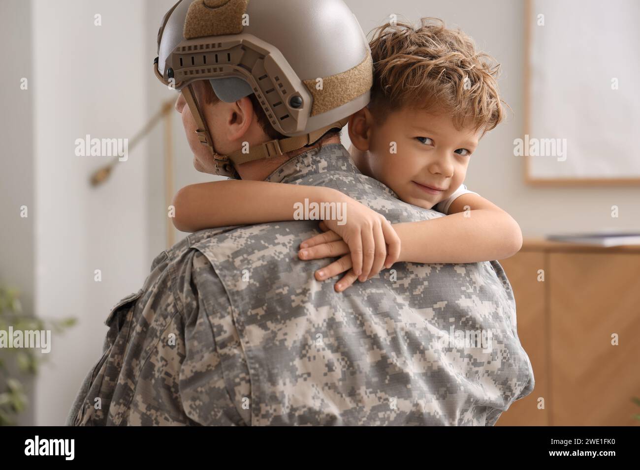 Little boy hugging his military father at home, closeup Stock Photo - Alamy