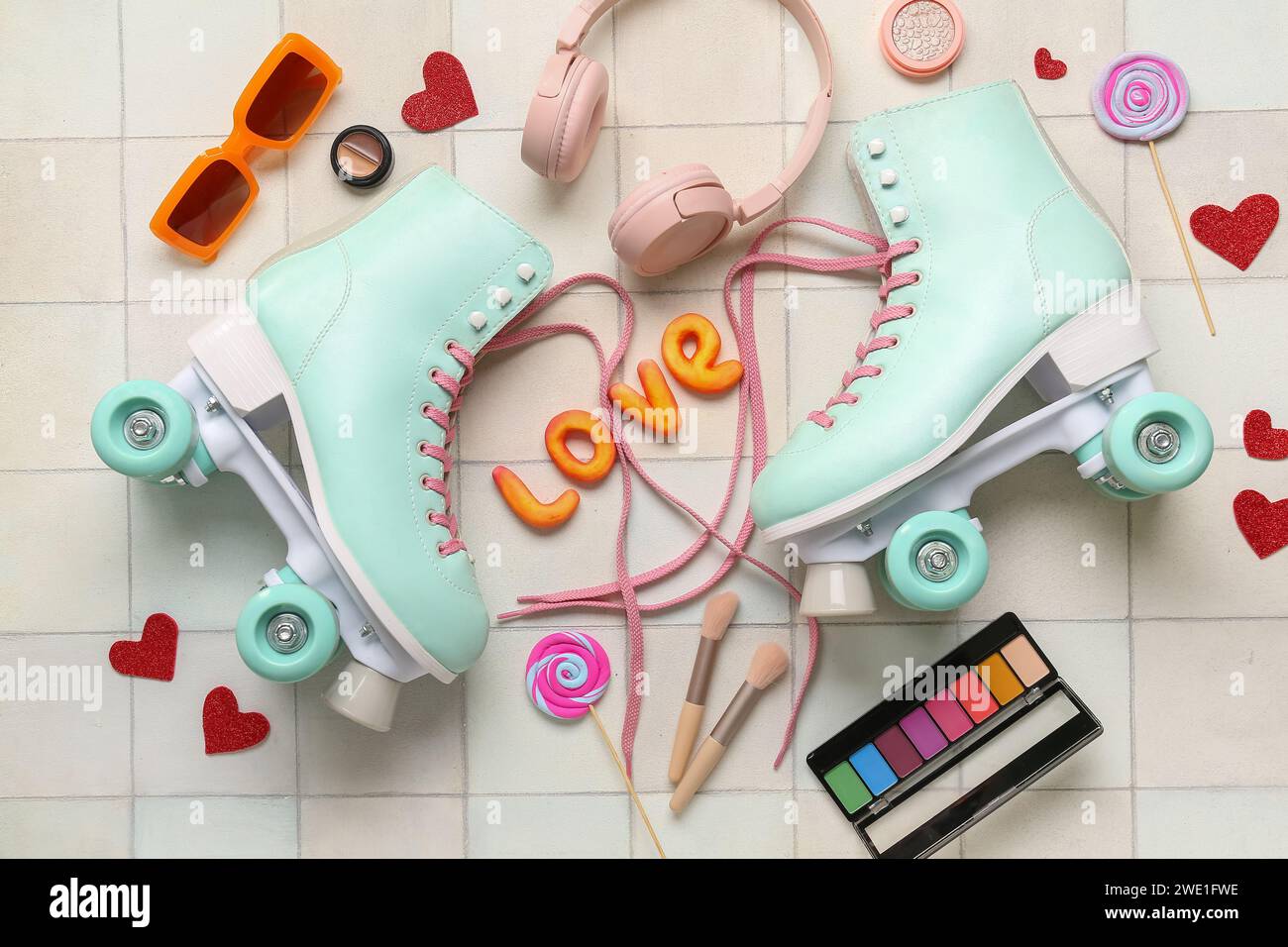 Composition with pair of vintage roller skates, modern headphones and ...