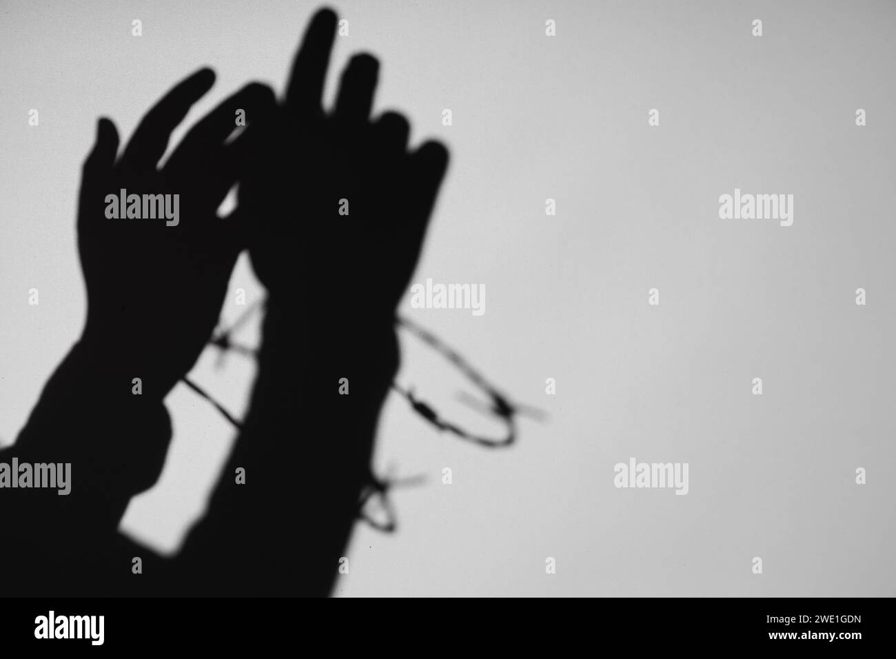Shadow of Jewish child with barbed wire on light background, closeup ...