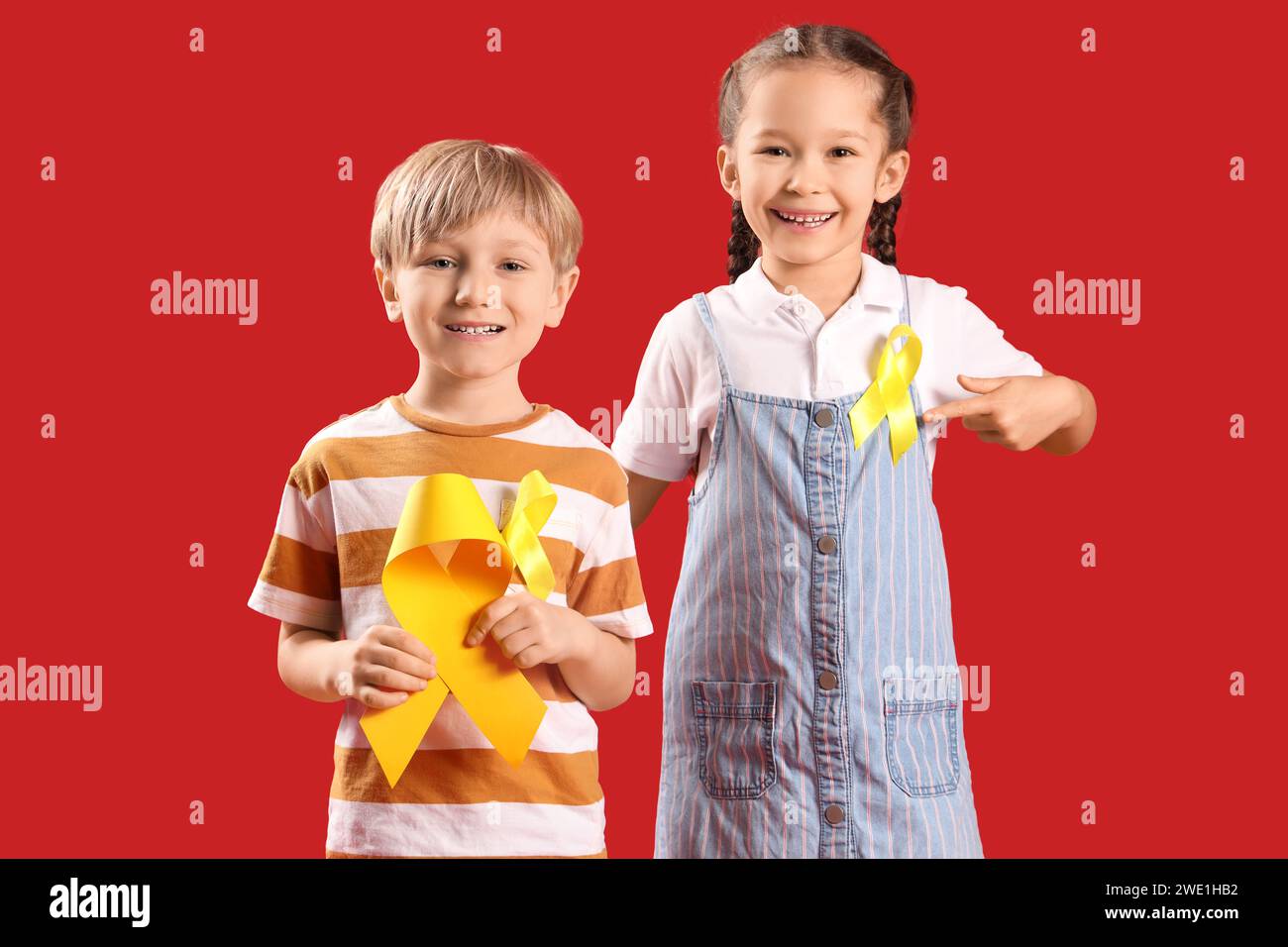 Cute little children with yellow ribbons on red background. Childhood ...