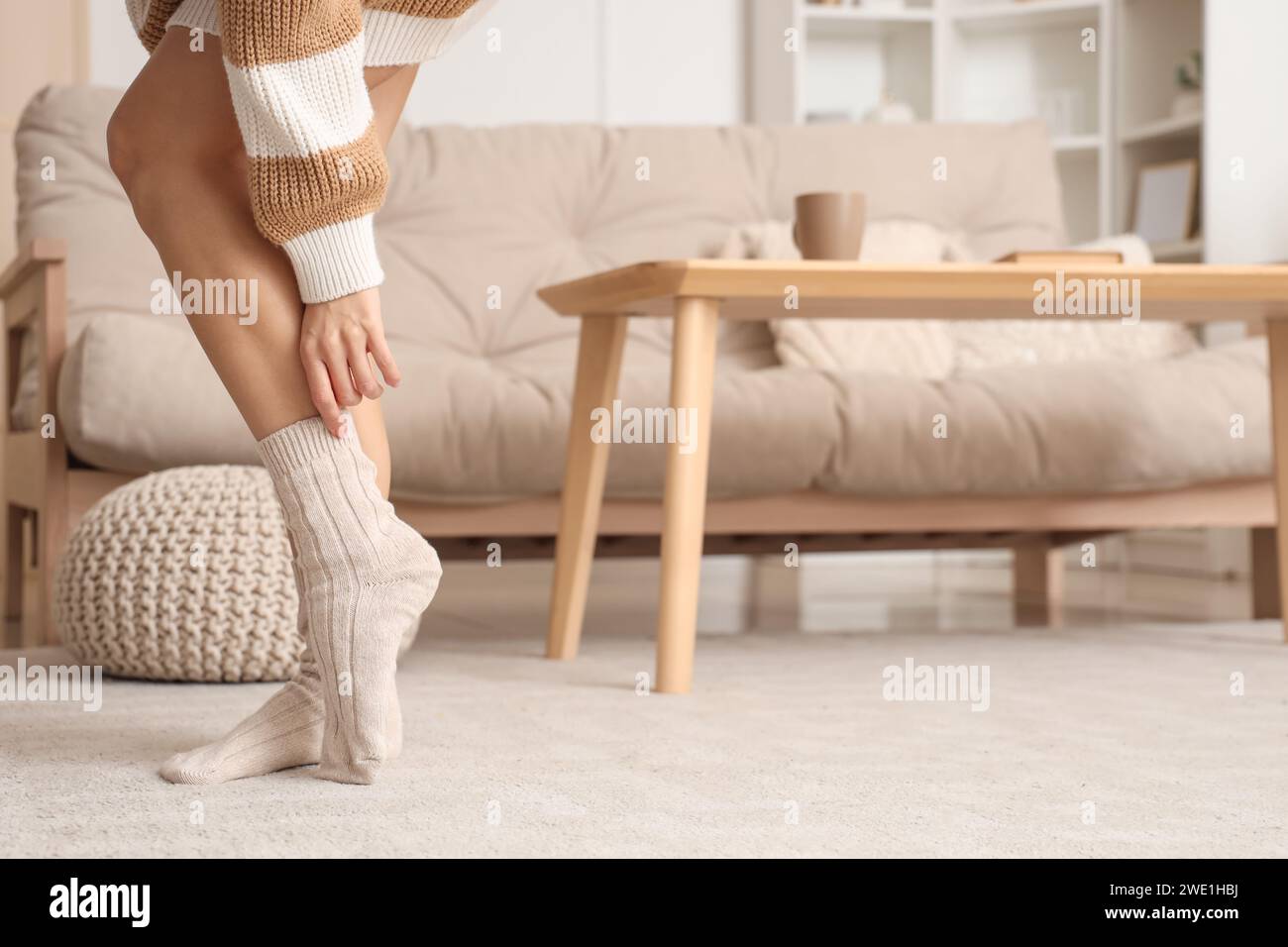 Woman wearing socks at home Stock Photo - Alamy