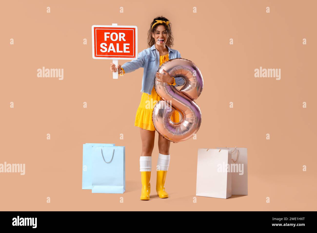 Fashionable African-American woman with balloon in shape of figure 8 ...