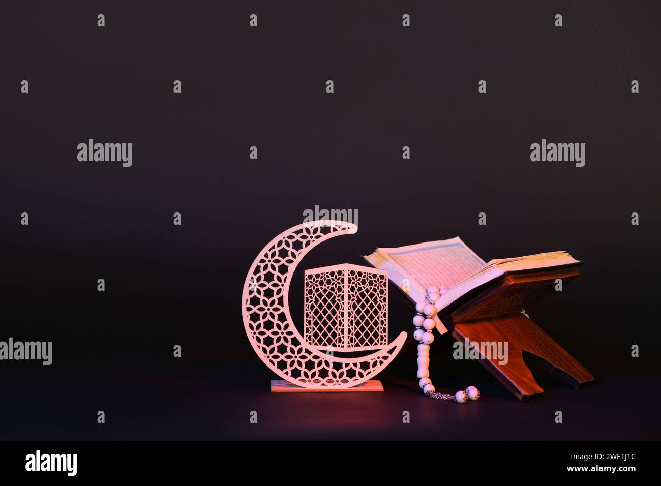 Rehal with Koran, prayer beads and decorative crescent for Ramadan on ...