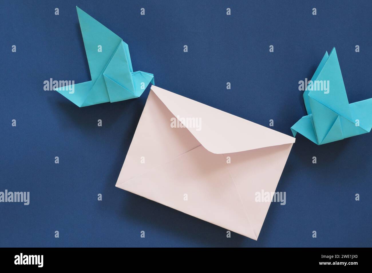 Two birds paper origami carrying letter envelope. Receiving and sending ...