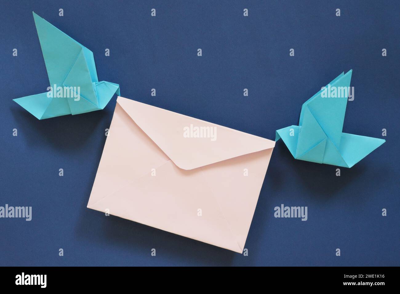 Two birds paper origami carrying letter envelope. Receiving and sending ...