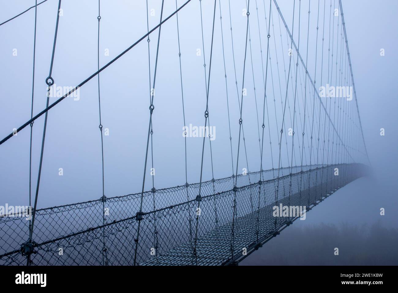 Foggy freezing winter morning, suspension bridge Stock Photo - Alamy