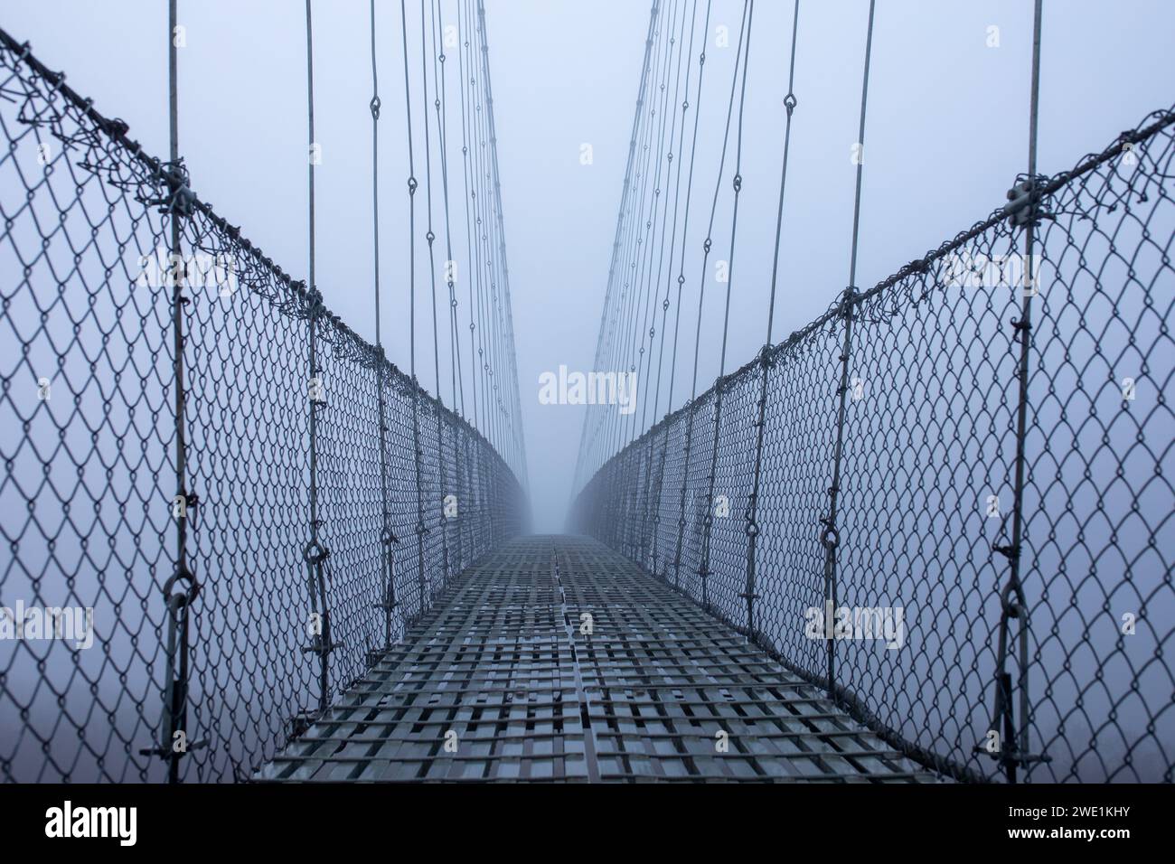 Foggy freezing winter morning, suspension bridge Stock Photo - Alamy