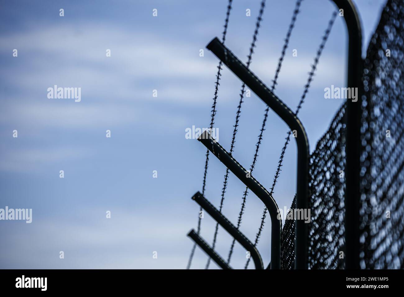 A separator fence in a field with anti-trespass spikes Stock Photo - Alamy