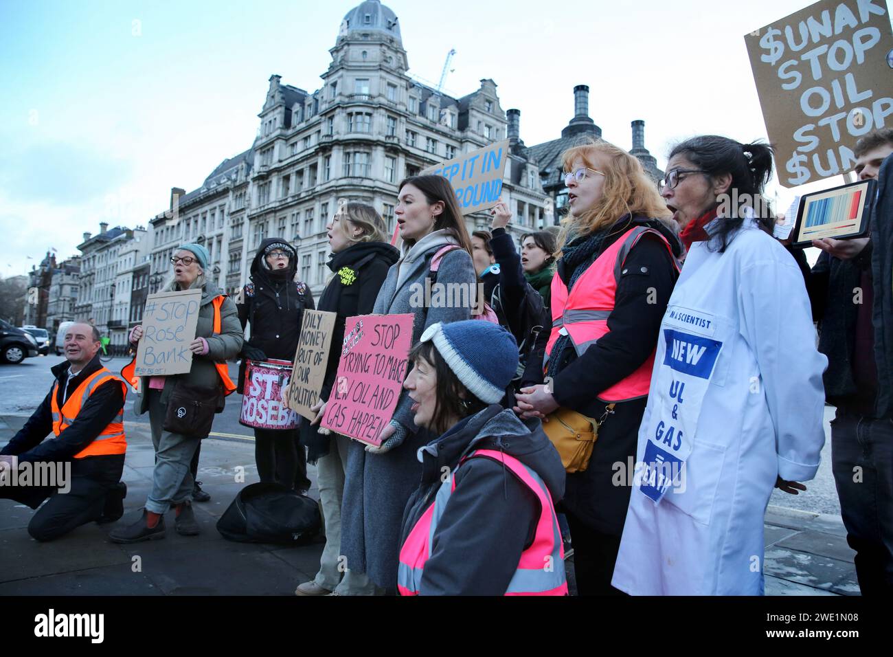 London, UK. 22nd Jan, 2024. Protesters hold placards expressing their ...