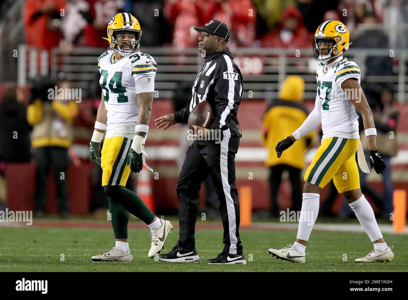 Green Bay Packers safety Jonathan Owens (34) speaks with field judge ...