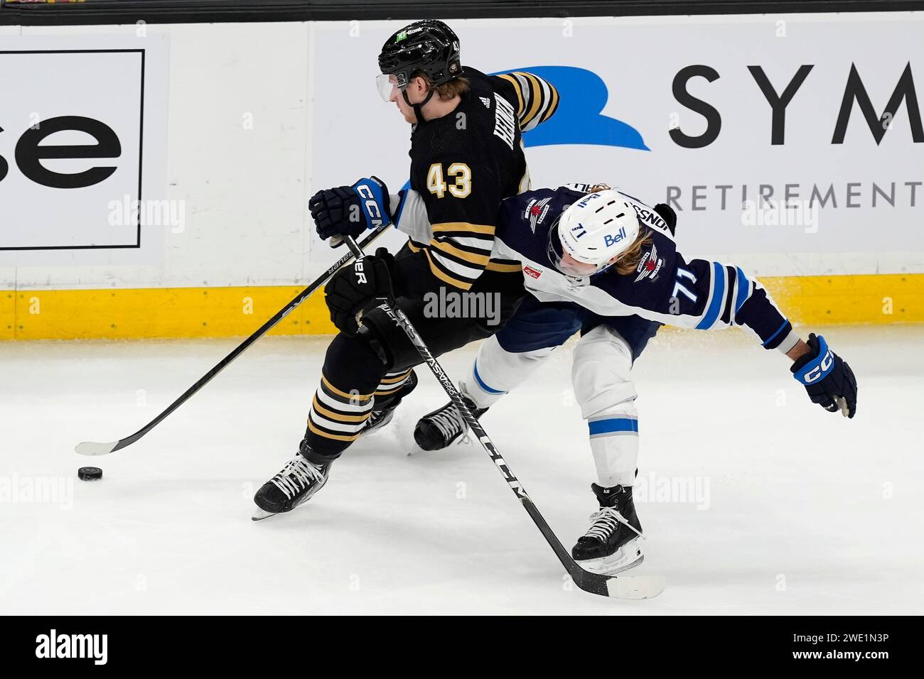 Winnipeg Jets' Axel Jonsson-Fjallby (71) and Boston Bruins' Danton Heinen (43) battle for the ...