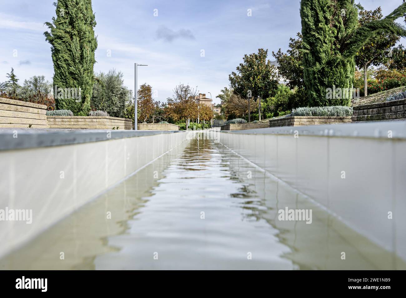 A small artificial water channel built with white tiles that transports ...